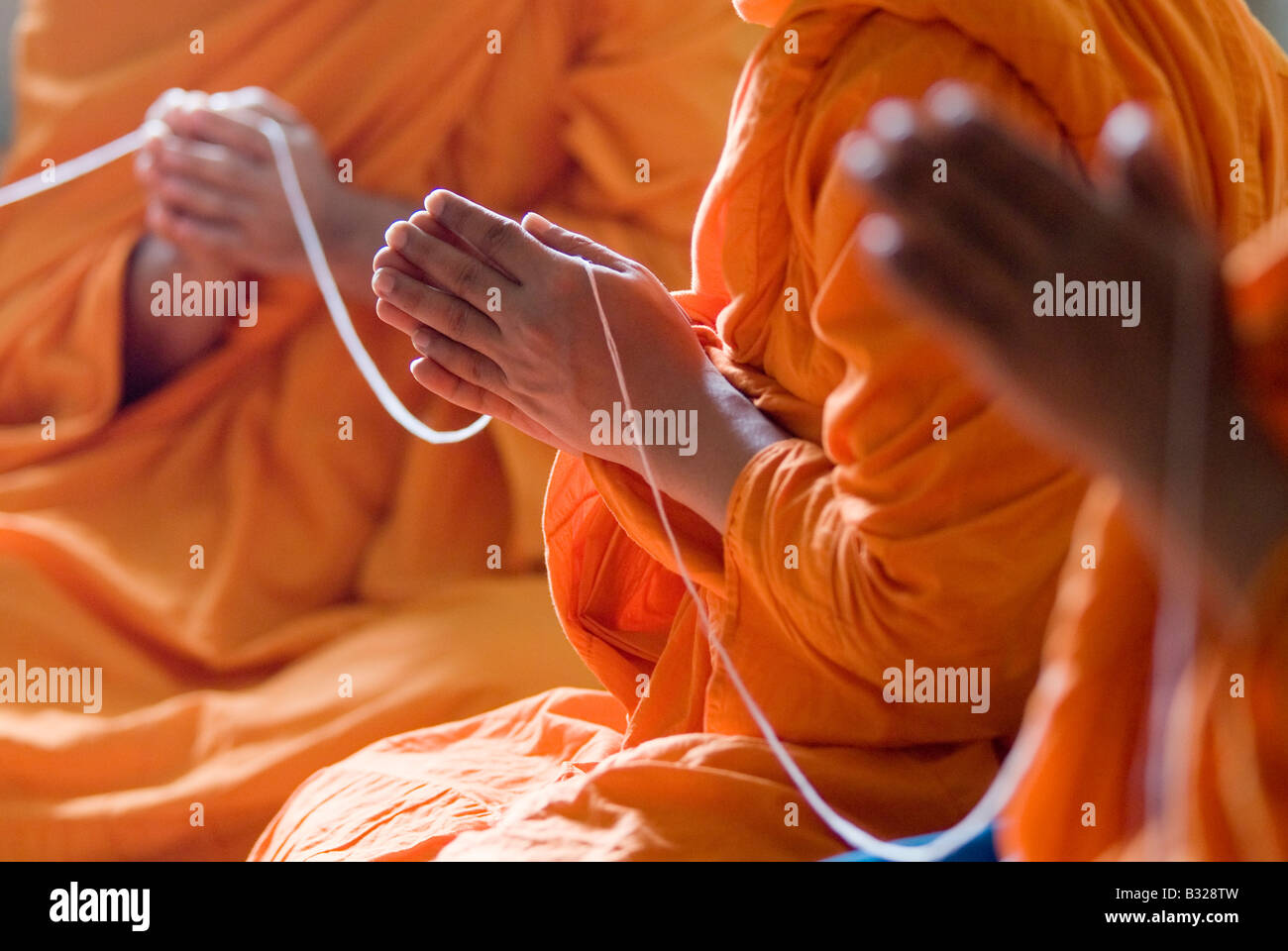 Thai Buddhist Monks hands praying Stock Photo - Alamy