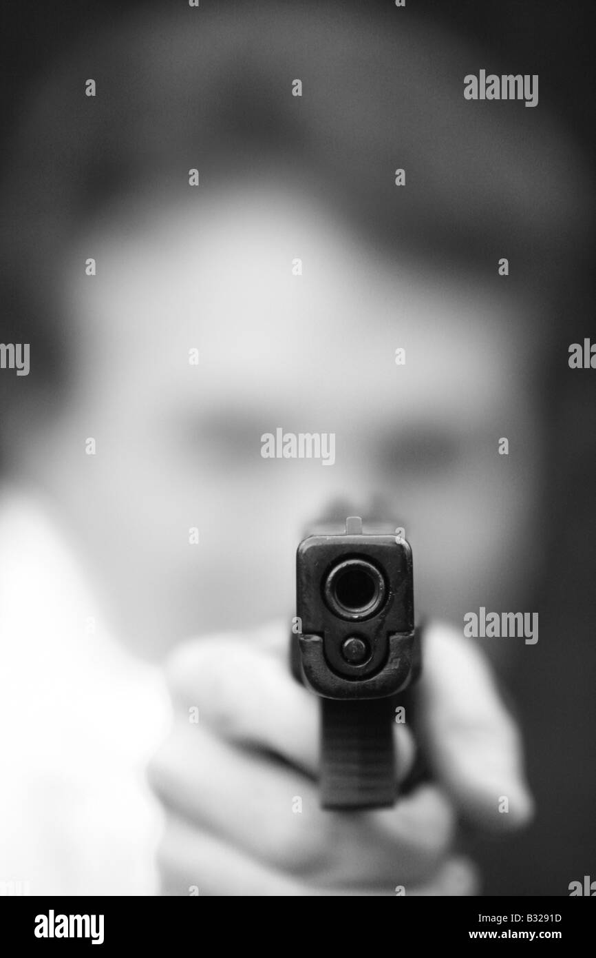 hitman gun shoot aim youth assasin asassin aim Stock Photo - Alamy