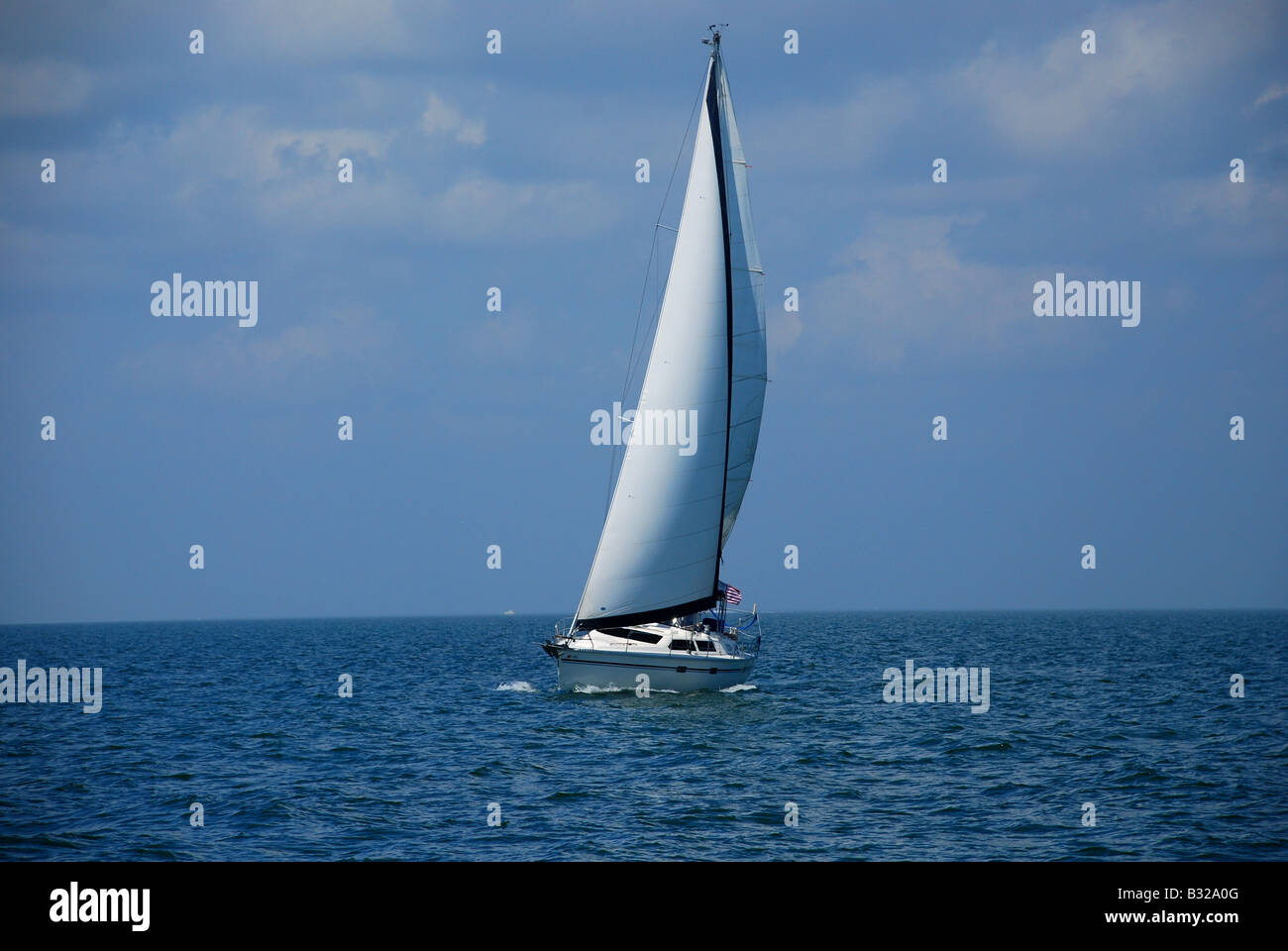 Sailboat under sail flying US flag Stock Photo - Alamy