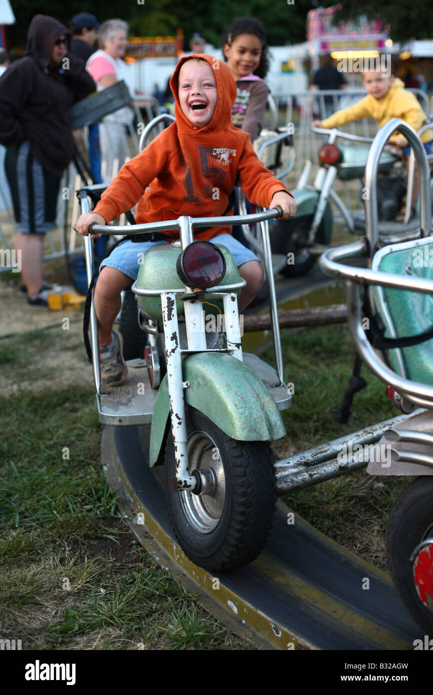 Young boy riding on motorcycle ride Stock Photo - Alamy