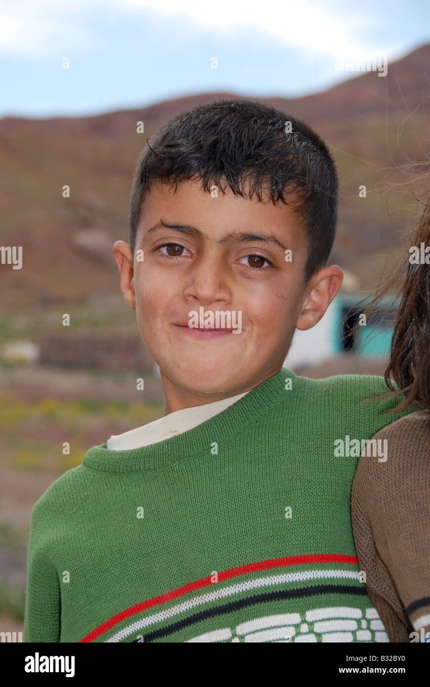 A young Kurdish boy standing in front of his house in Turkey Stock ...