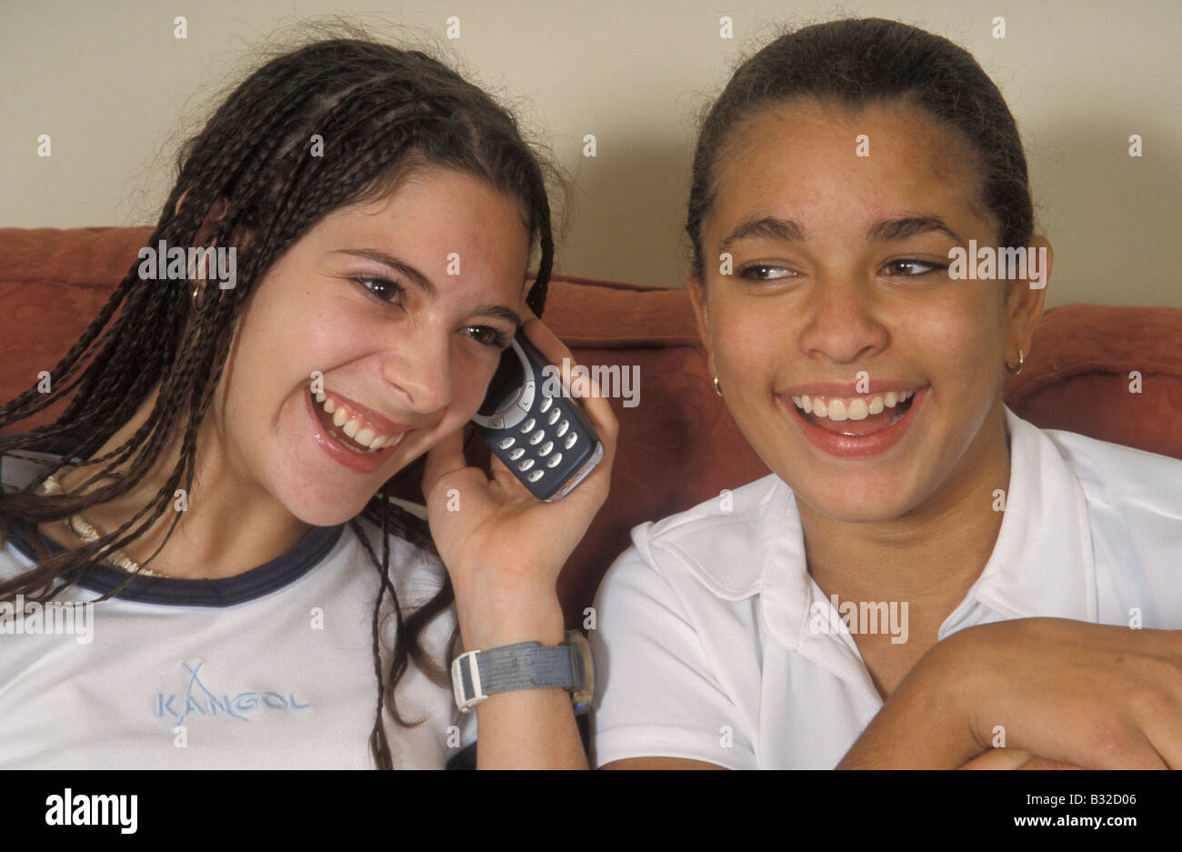 two girl friends chatting on mobile phone Stock Photo - Alamy