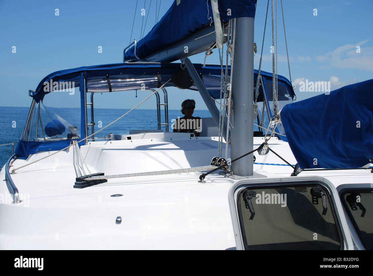 Woman Captain at the Helm of a Catamaran Sailboat Stock Photo - Alamy