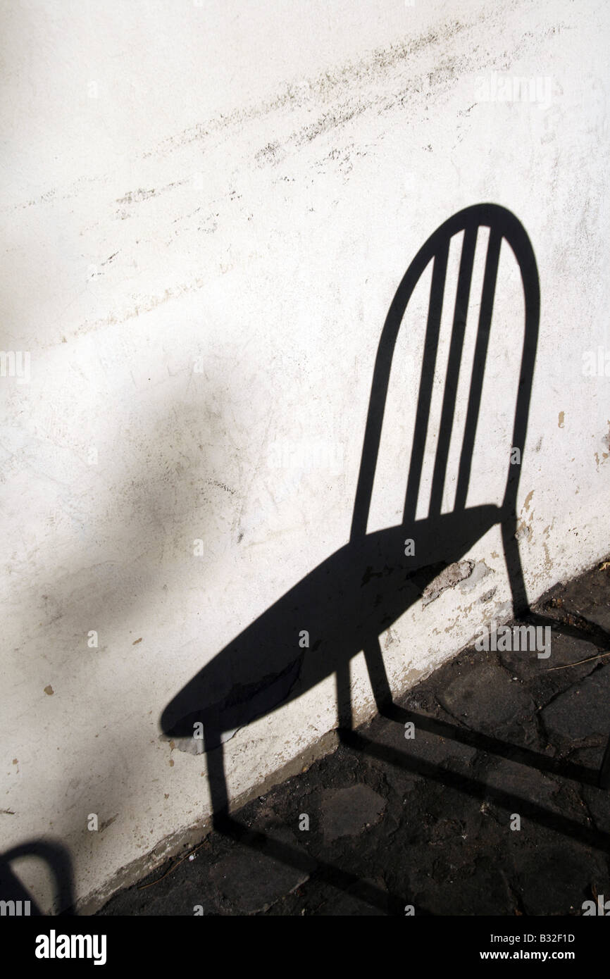 one single chair shadow on wall outdoors Stock Photo - Alamy
