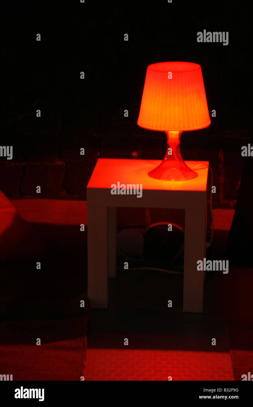 one red table lamp in dark setting outdoors Stock Photo - Alamy