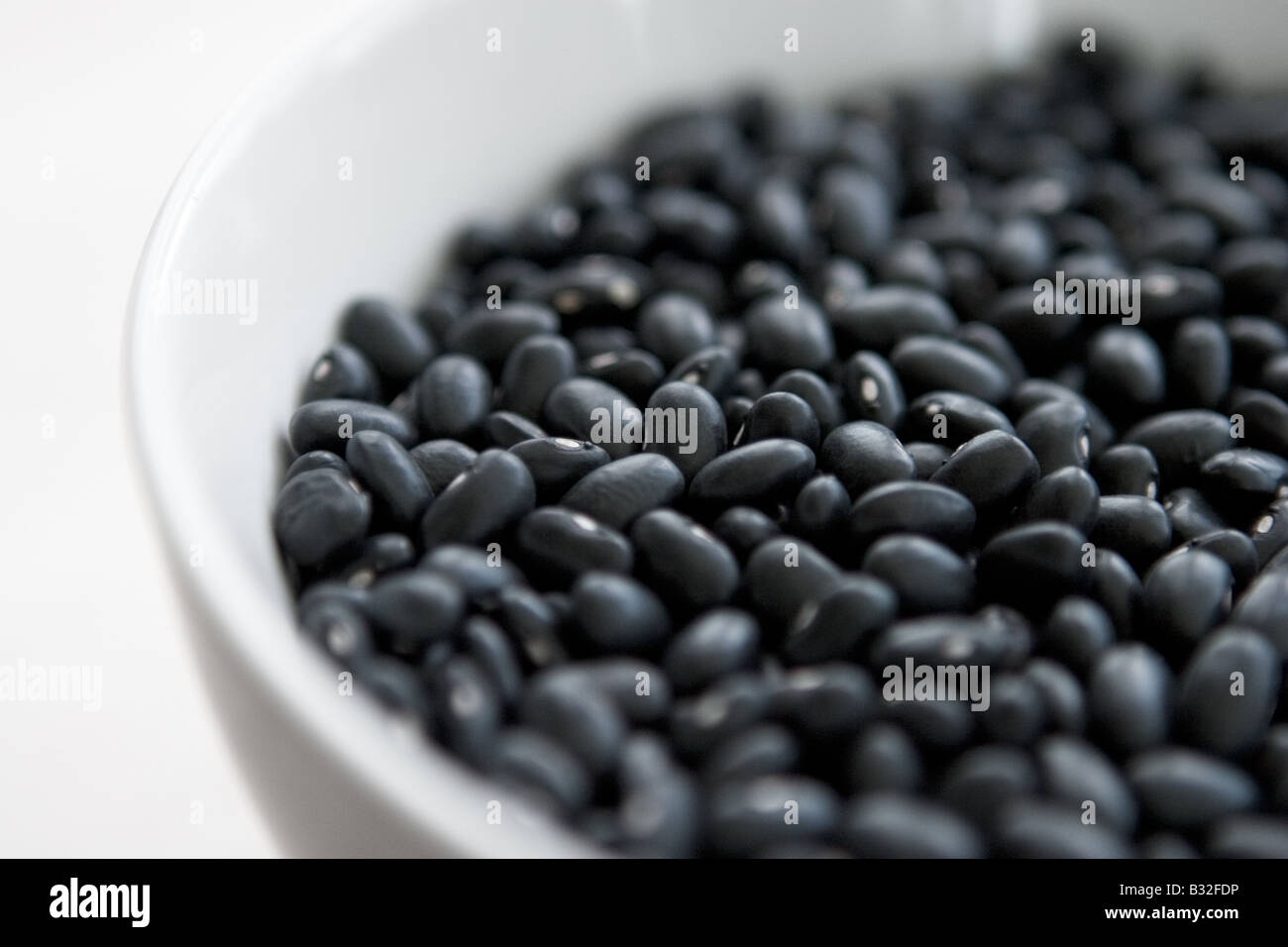 Black Turtle Beans in White Bowl Stock Photo - Alamy