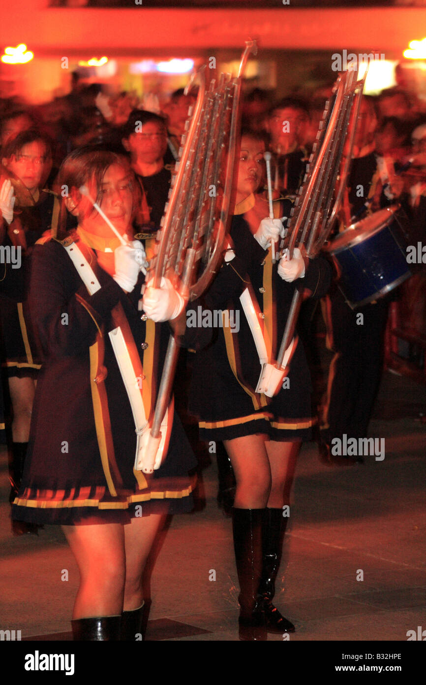 two girls of an high school marching band during a catholic procession ...
