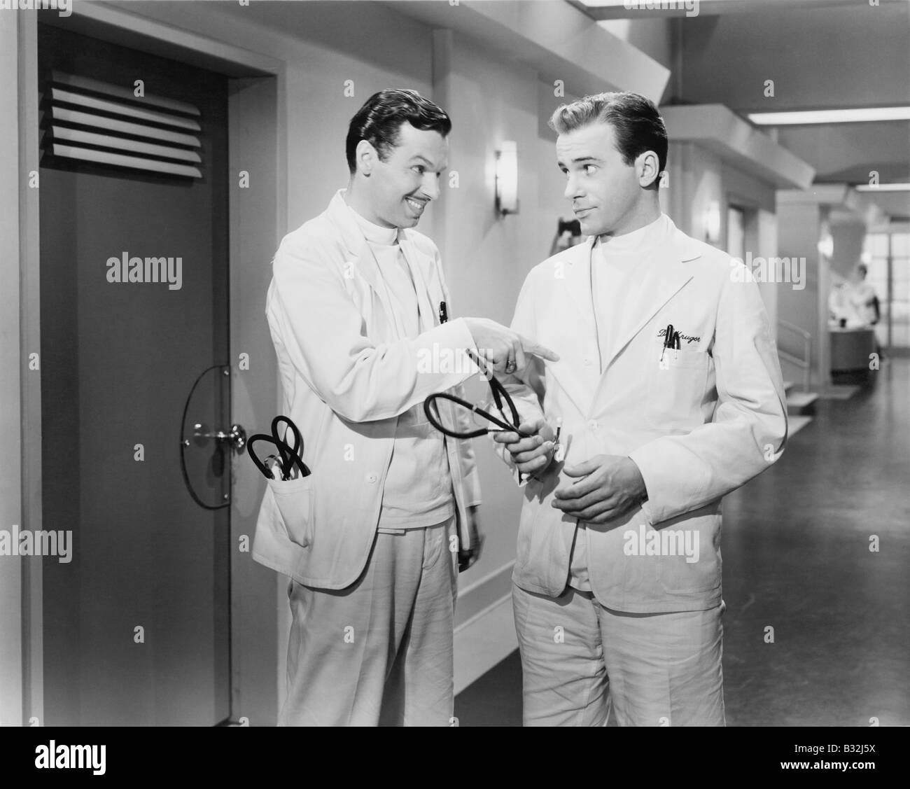 Smiling young doctor in white Black and White Stock Photos & Images - Alamy