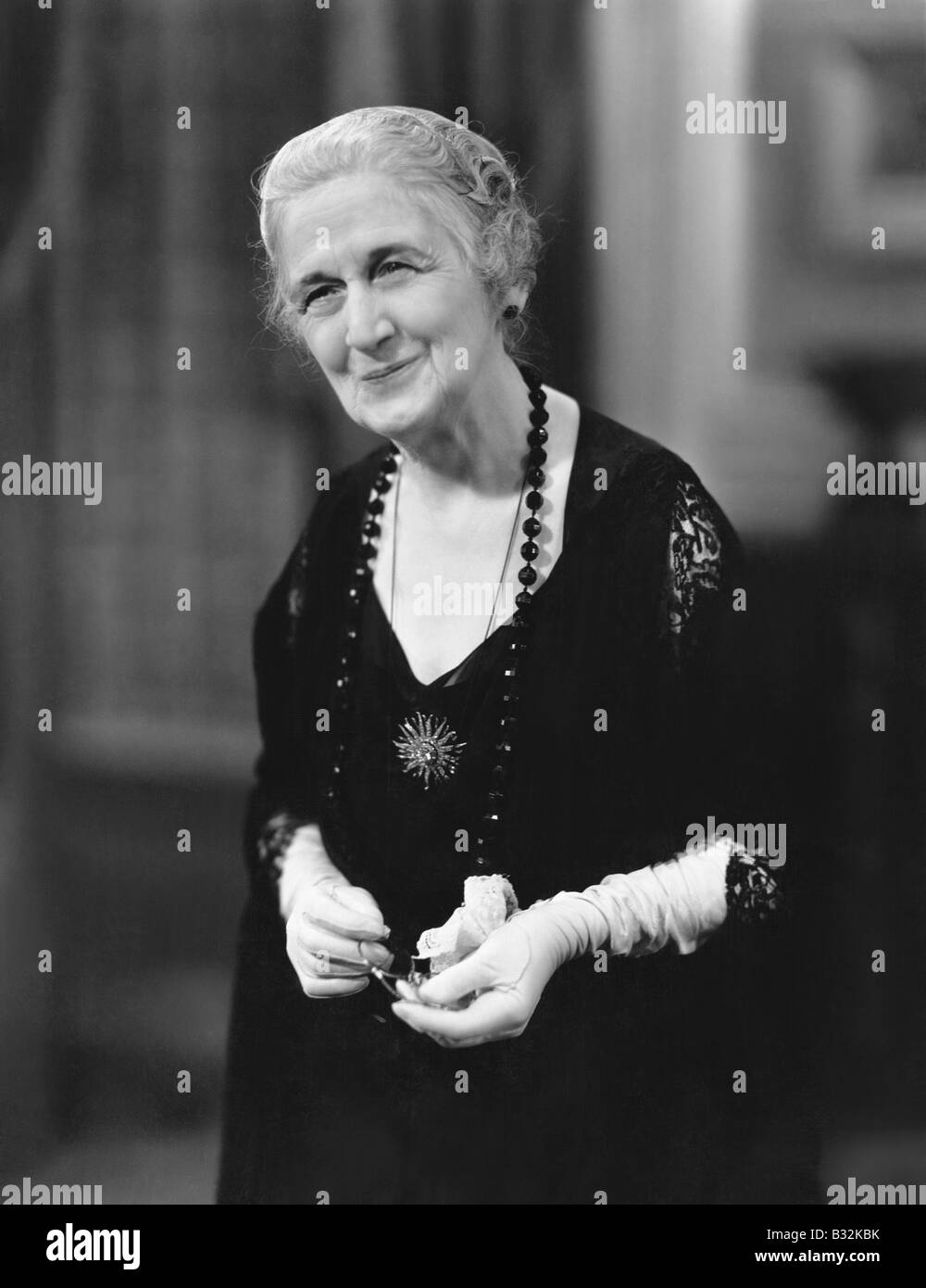 Mature woman standing smiling Black and White Stock Photos & Images - Alamy