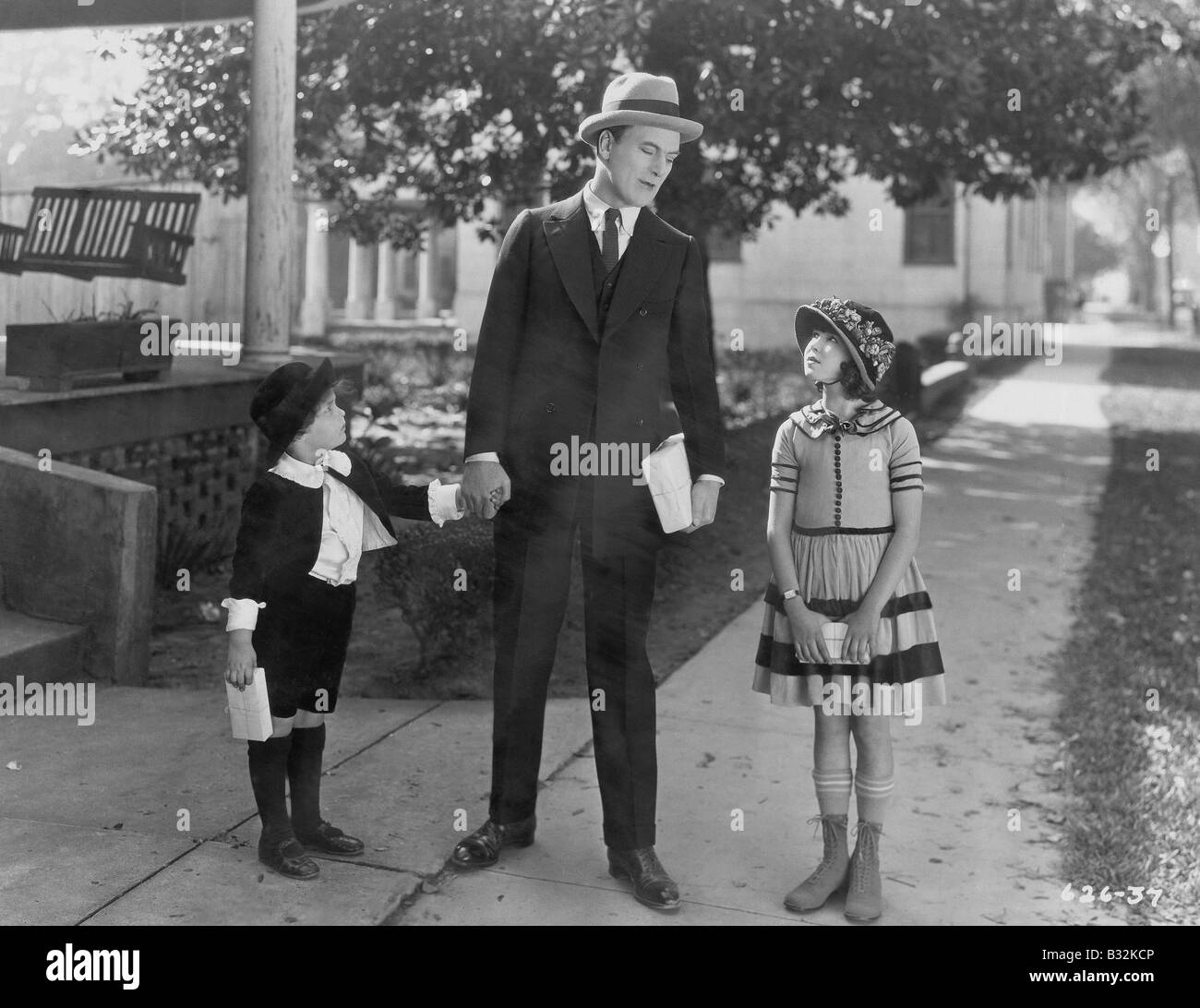 Father talking to two children outside Stock Photo - Alamy