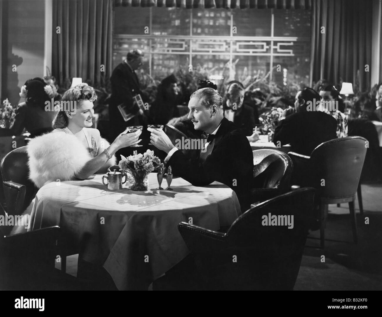 Couple dining in crowded restaurant Stock Photo - Alamy