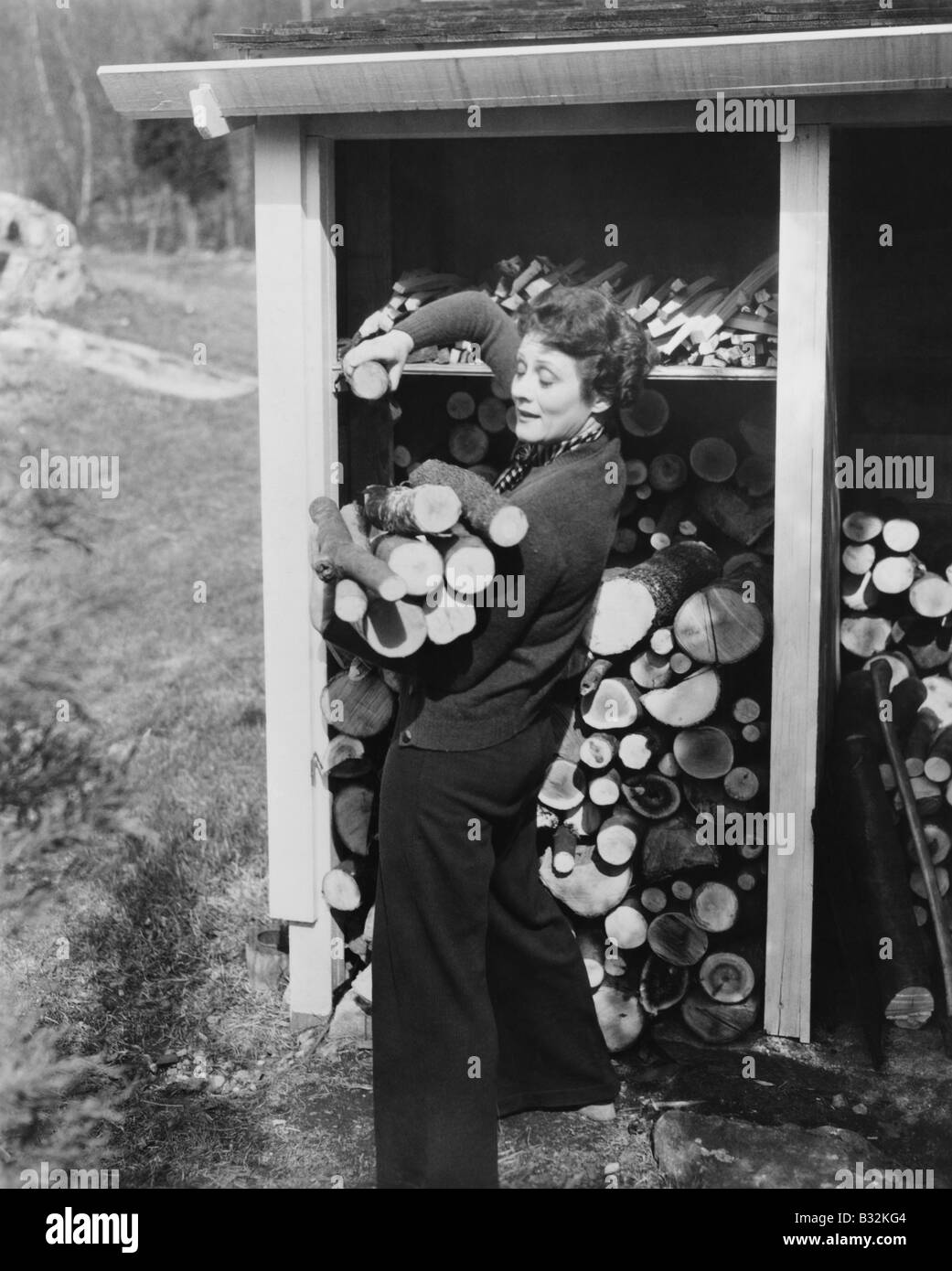 Woman carrying firewood logs hi-res stock photography and images - Alamy