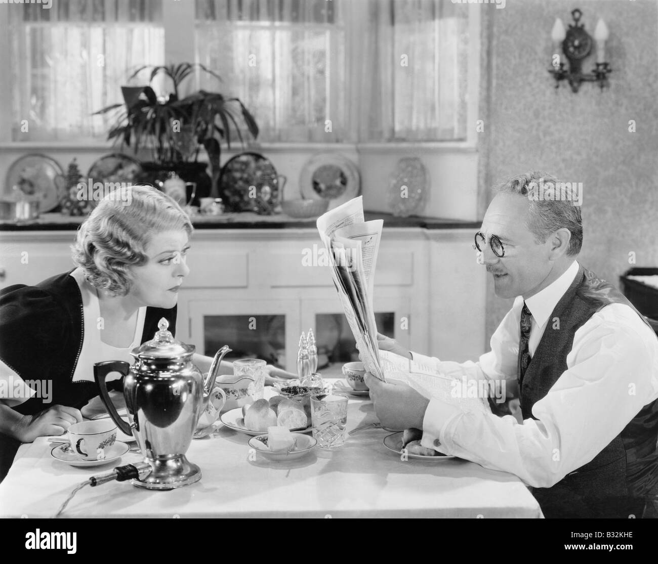 Newspaper reading man table Black and White Stock Photos & Images - Alamy