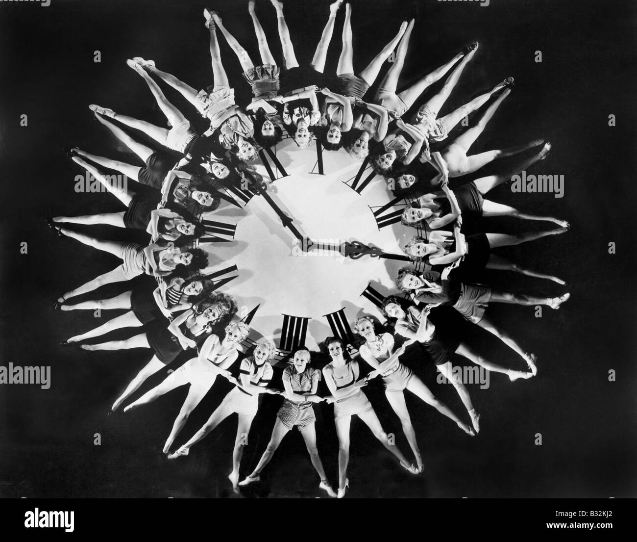 Female dancers circling huge clock Stock Photo - Alamy