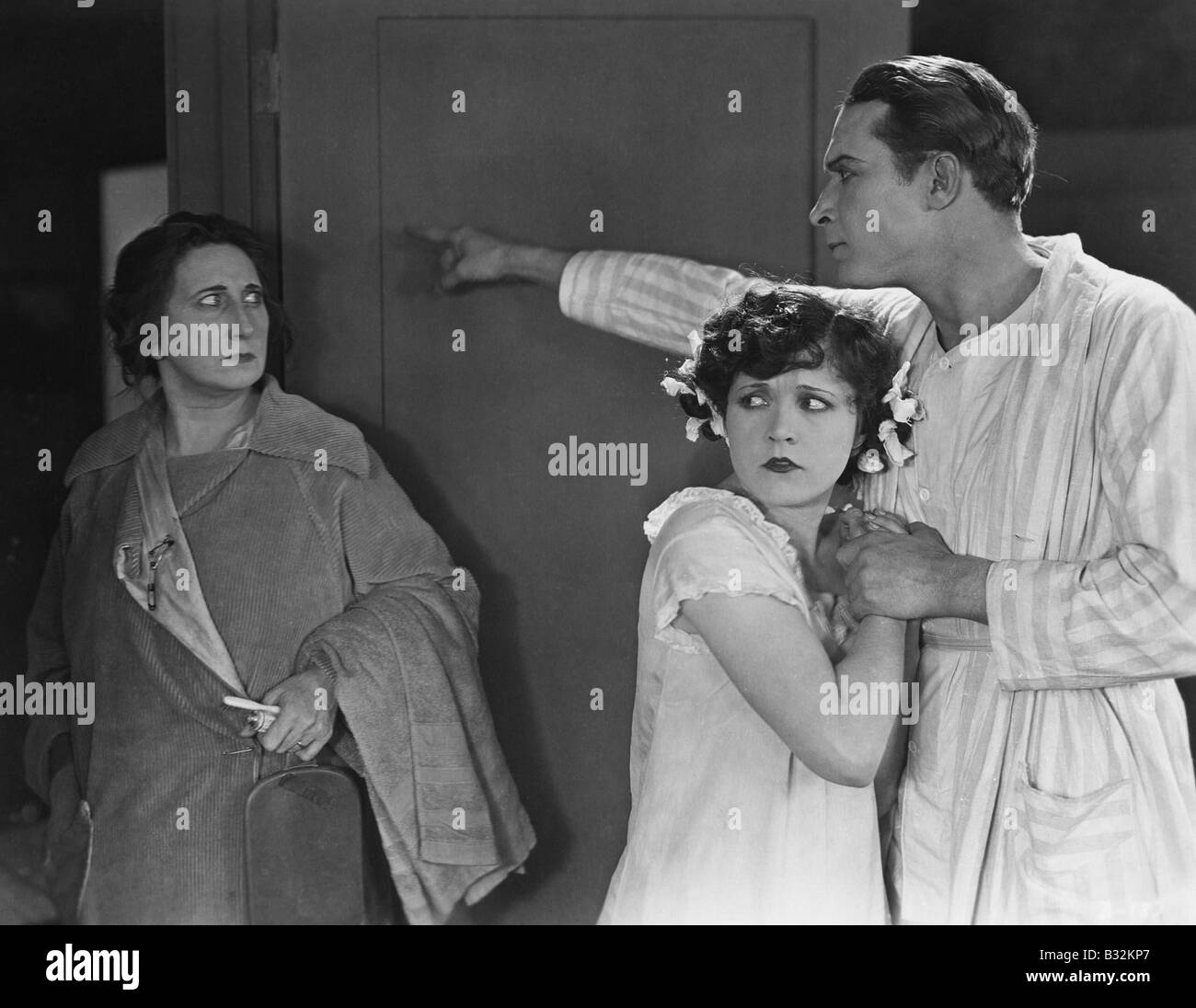 Couple sending woman away Stock Photo - Alamy