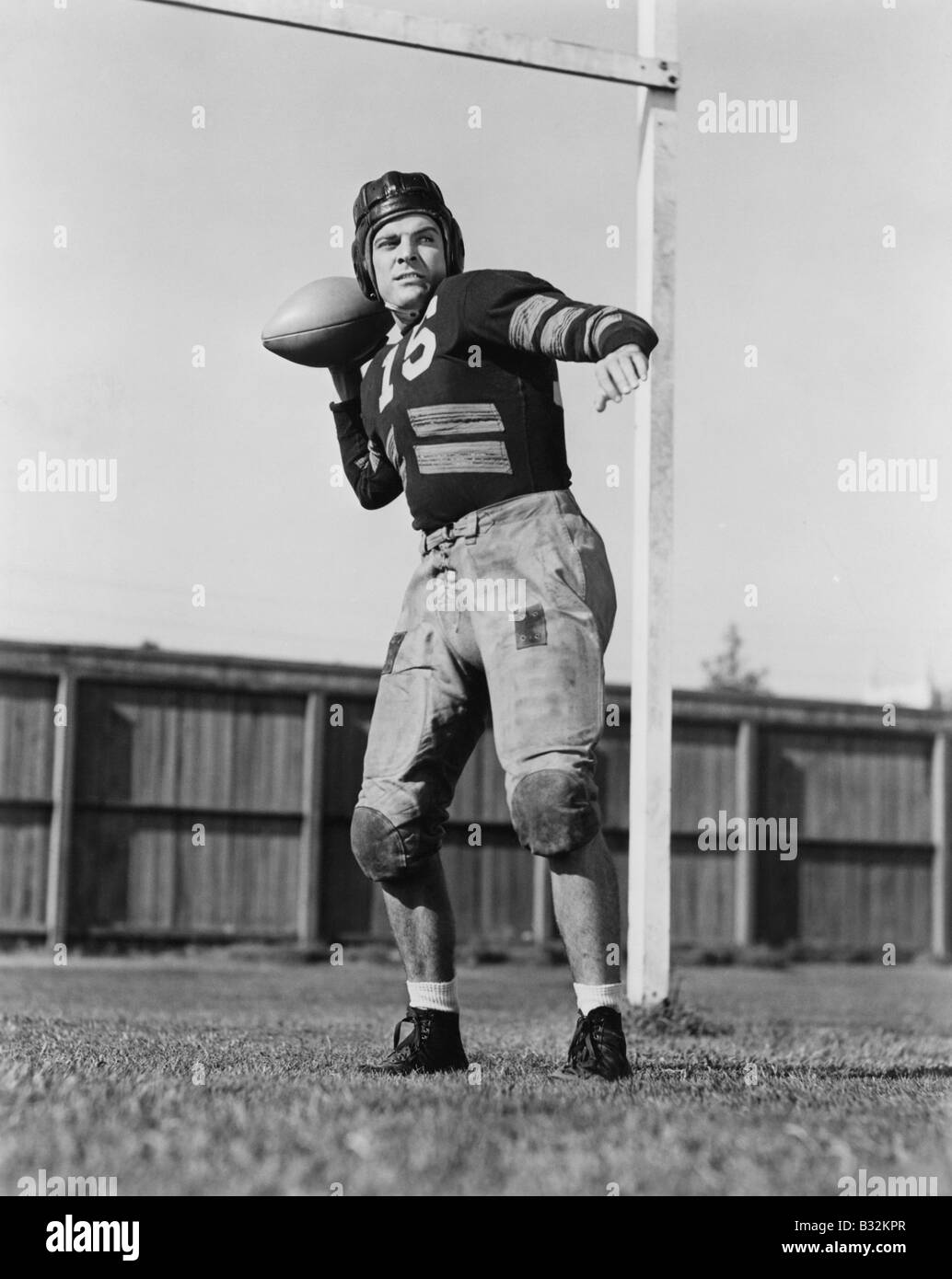 Football player throwing ball Stock Photo - Alamy
