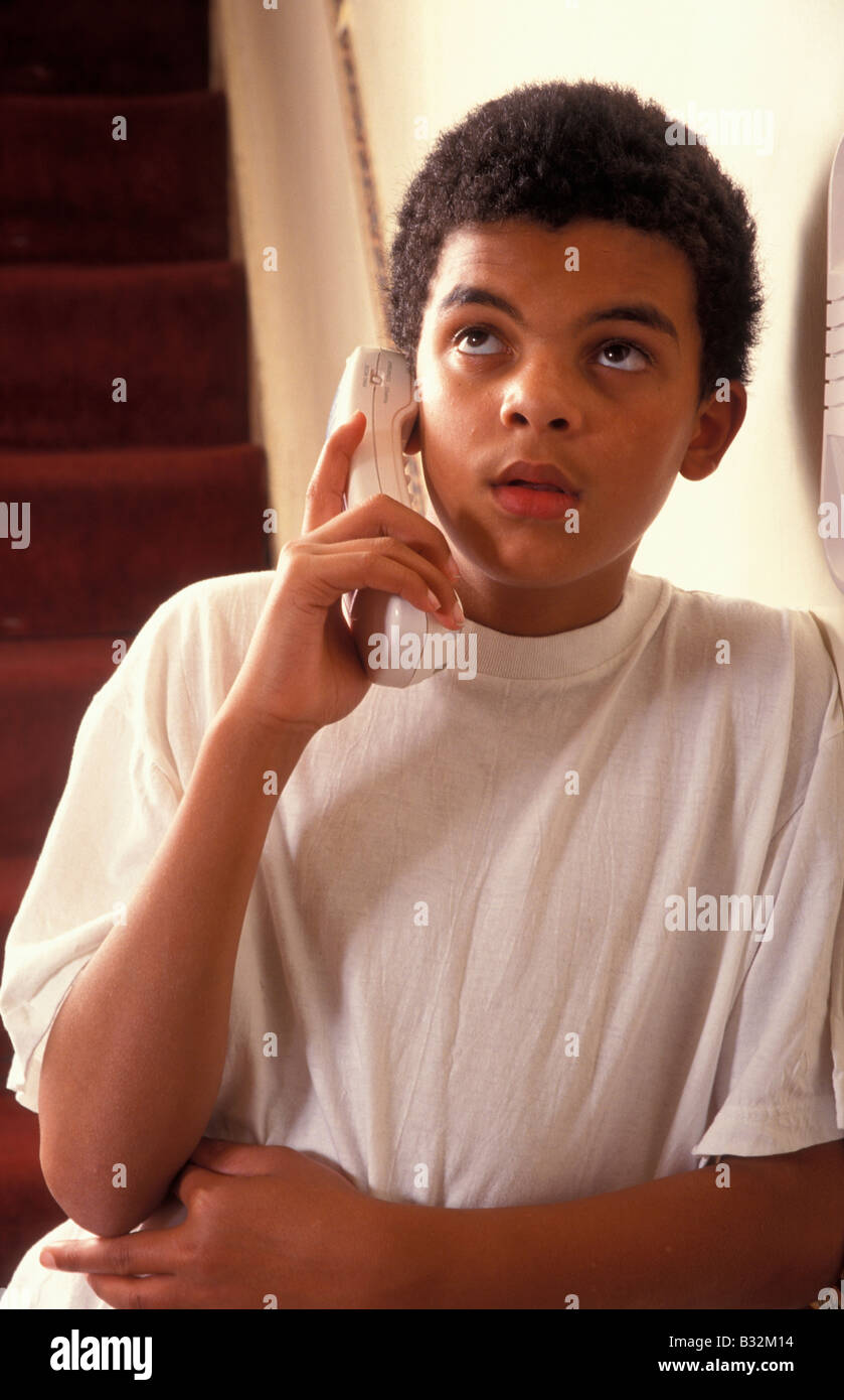black teenage boy having conversation on telephone Stock Photo - Alamy