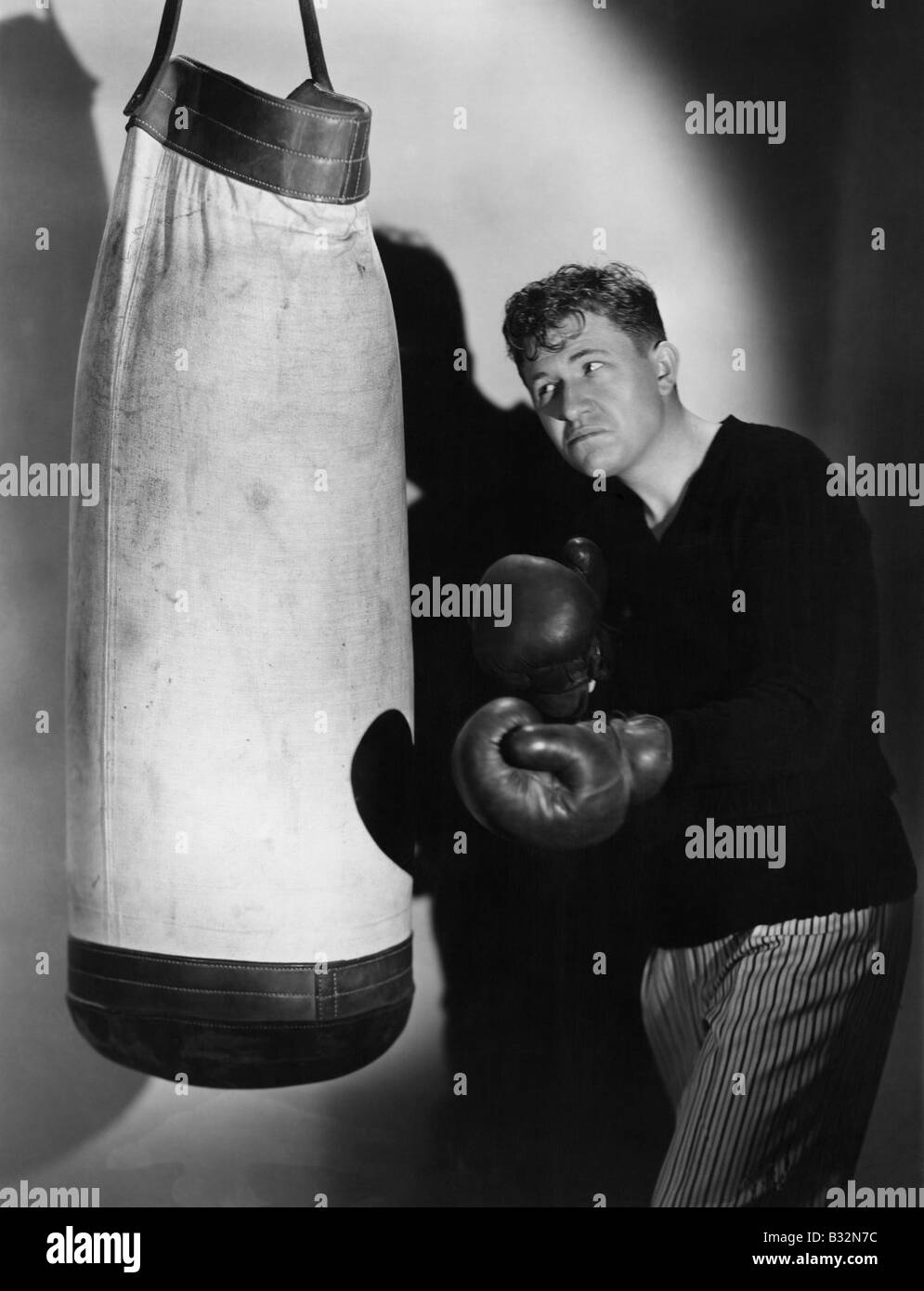Boxer using punching bag Stock Photo - Alamy