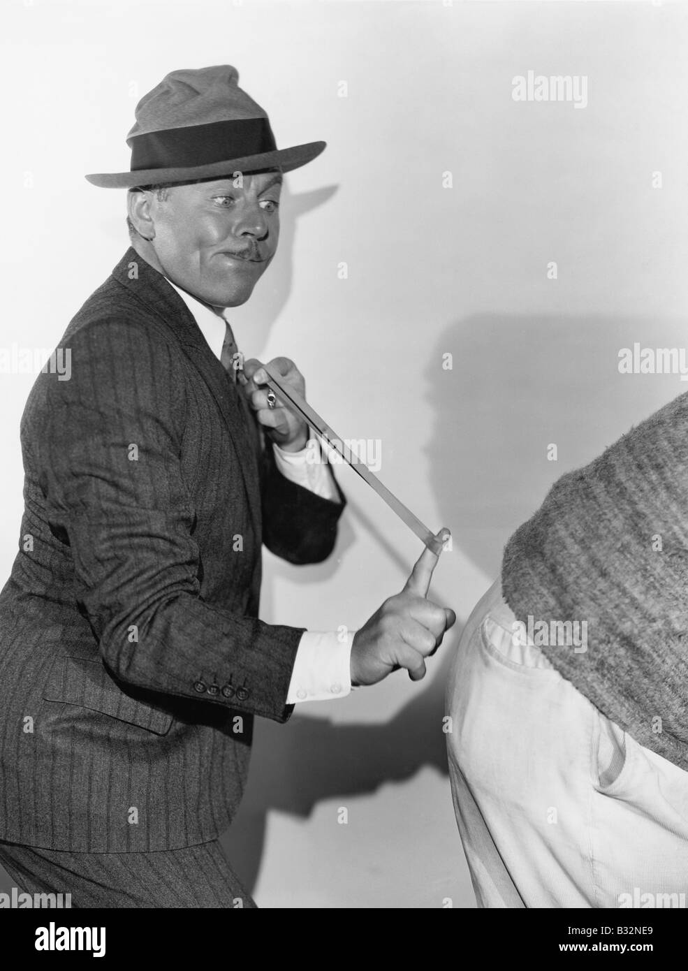 Man snapping rear end with rubber band Stock Photo - Alamy