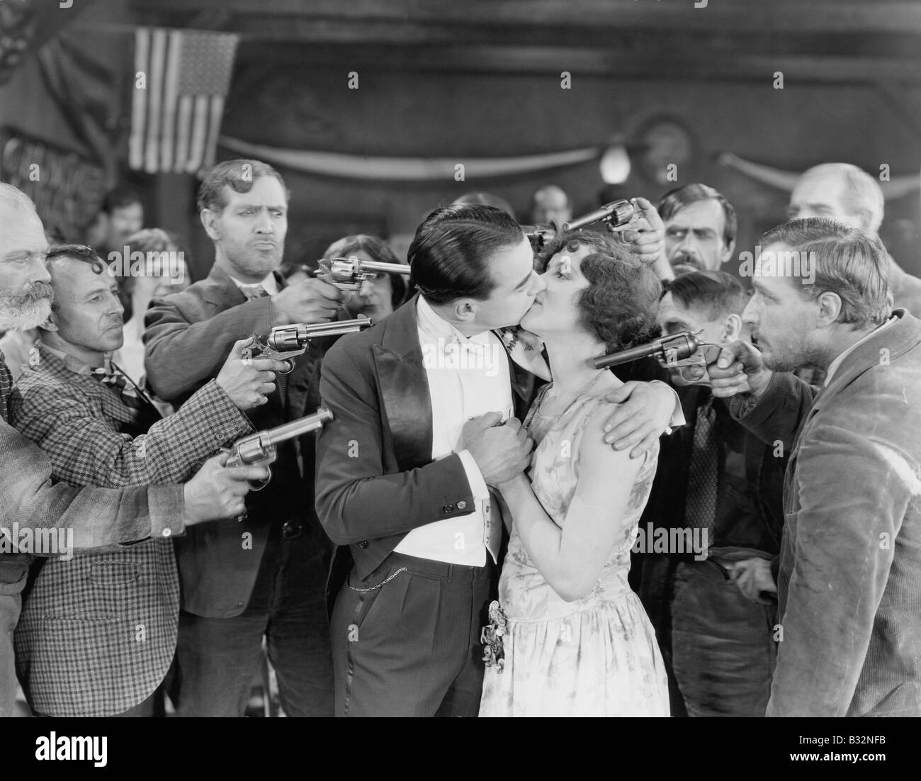 Kissing couple surrounded by men with guns Stock Photo - Alamy