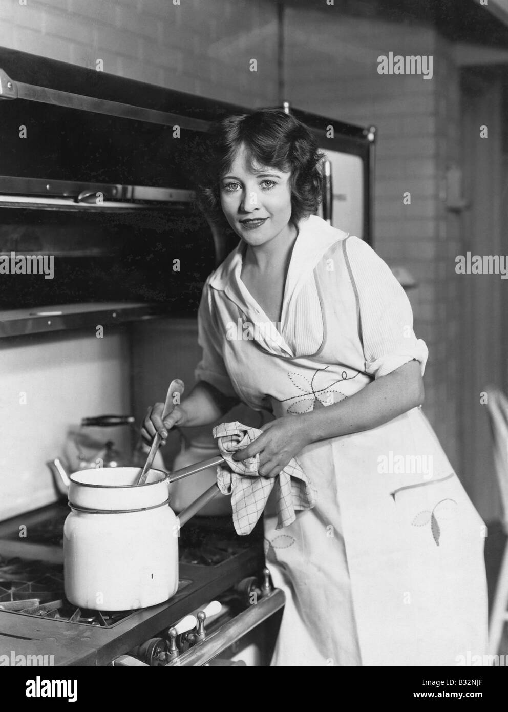 Woman stirring pot on stove hi-res stock photography and images - Alamy