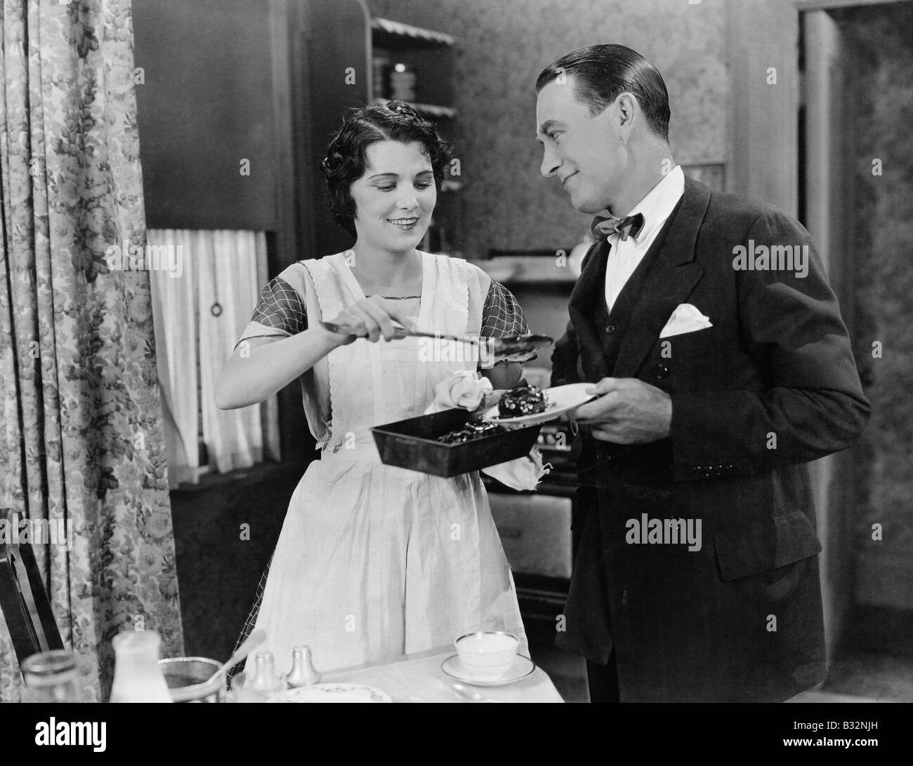 Woman serving food to man Stock Photo - Alamy