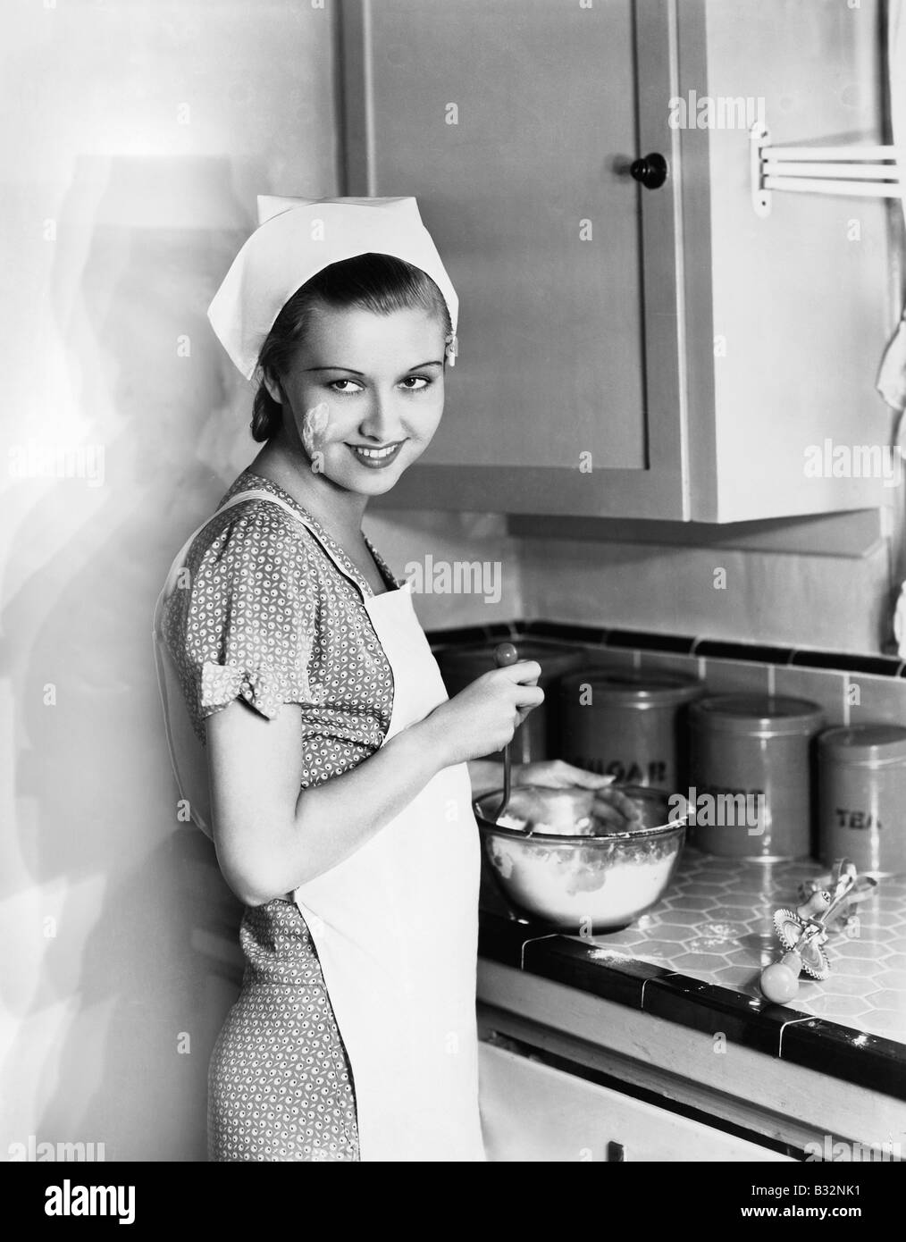 Portrait of woman cooking with flour on face Stock Photo - Alamy