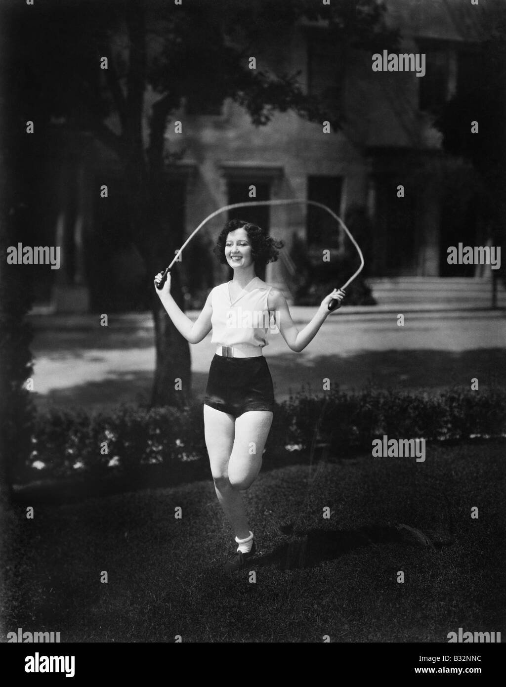 Athletic young woman exercising Black and White Stock Photos & Images ...