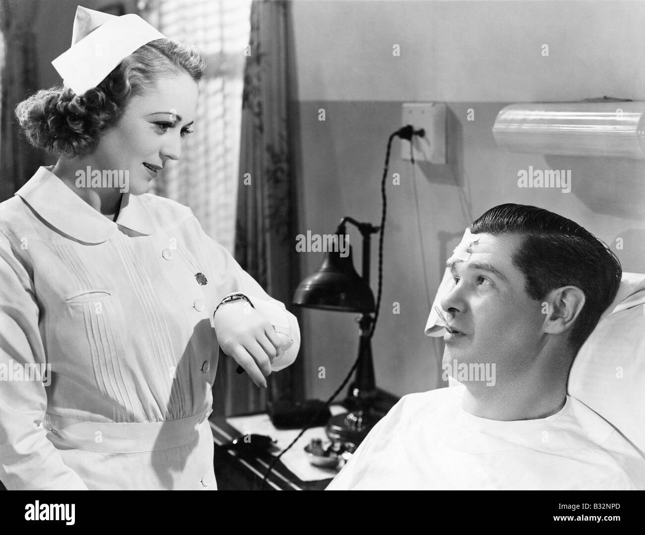 Nurse taking female patient temperature hi-res stock photography and ...