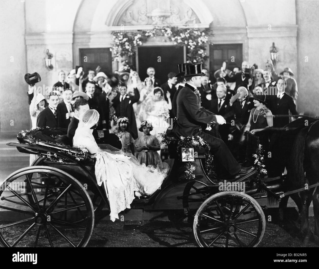 Newlyweds leaving wedding in carriage Stock Photo - Alamy