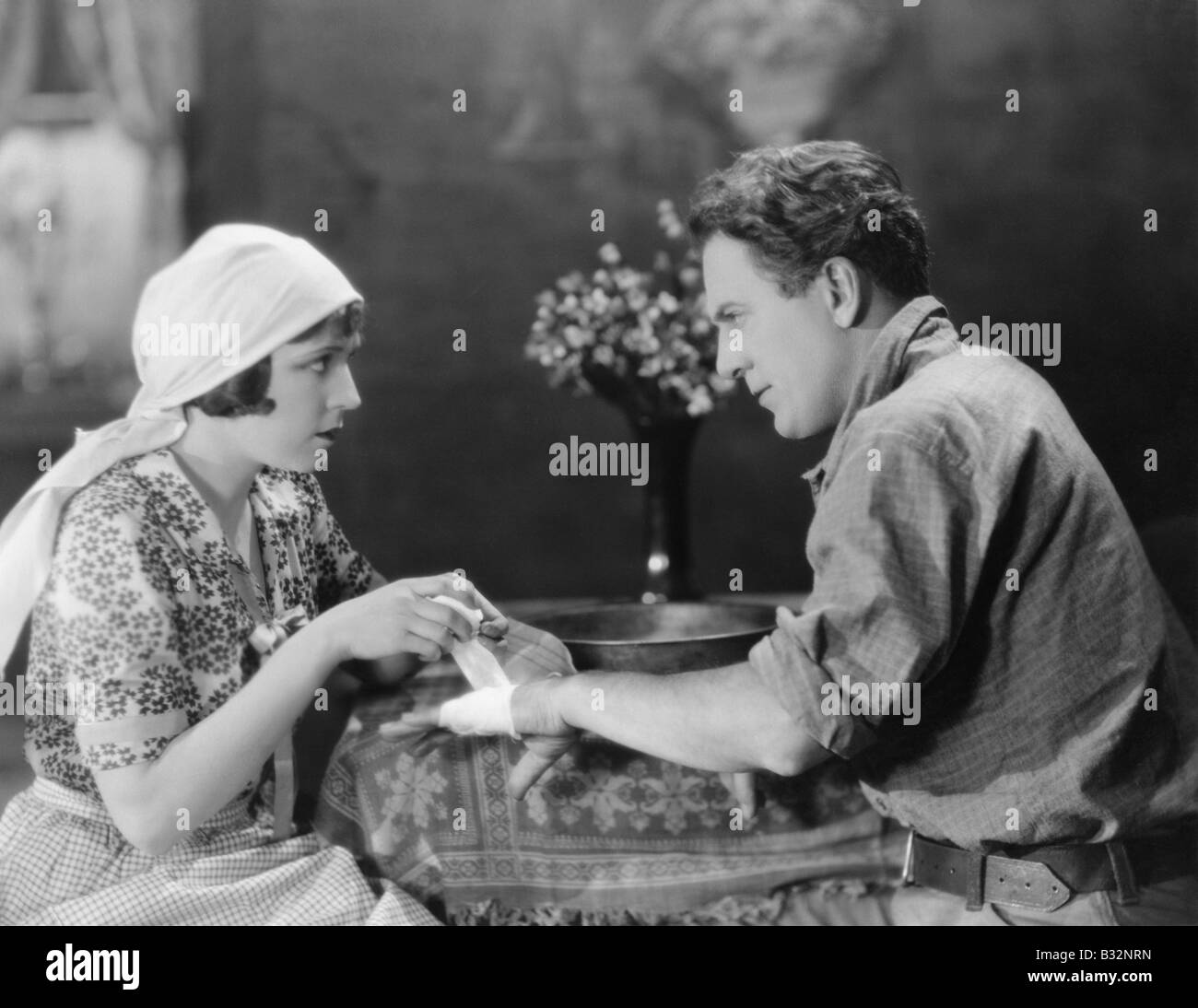 Woman bandaging mans hand Stock Photo - Alamy