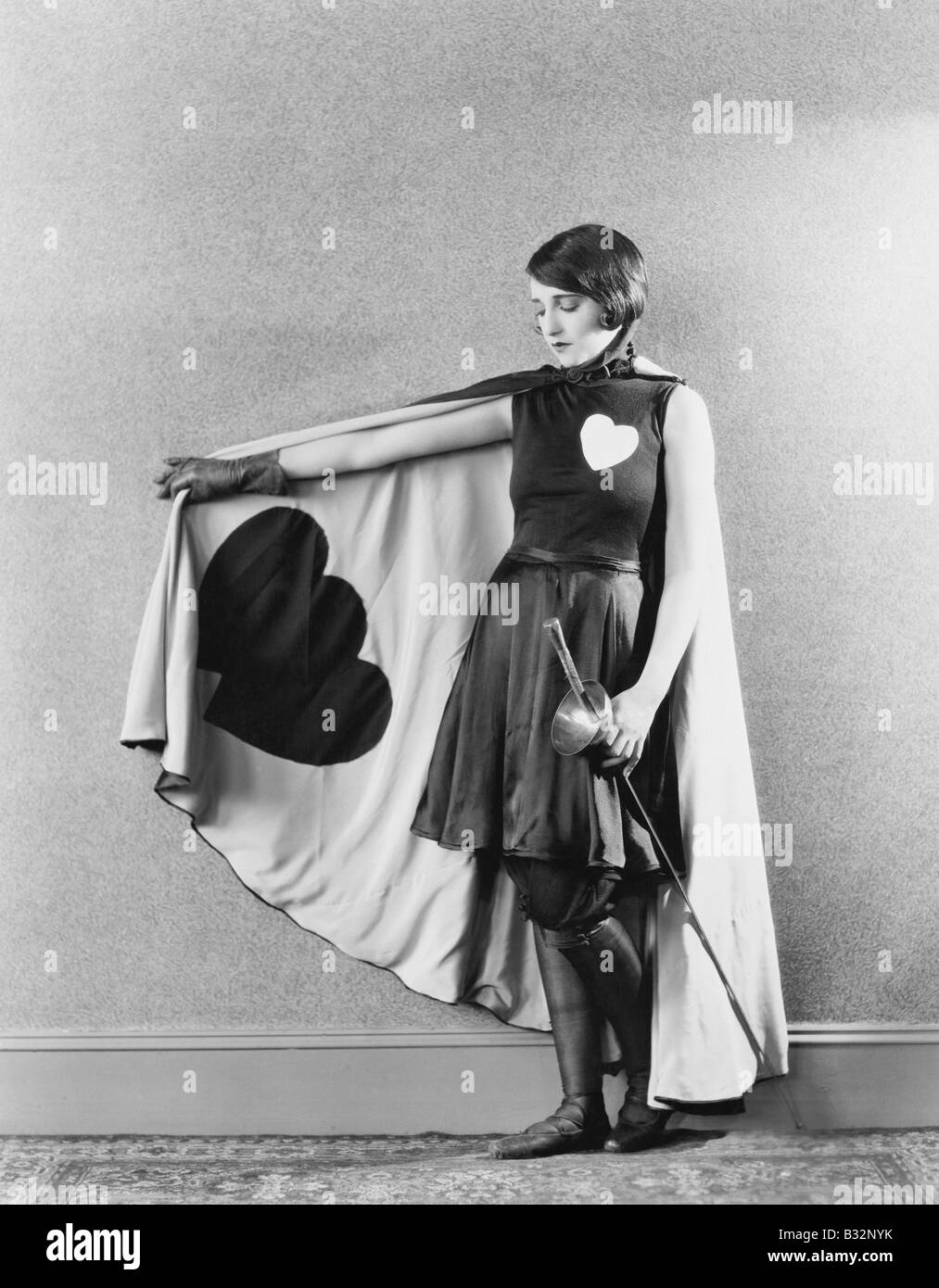 Female sword fighter wearing cape with hearts Stock Photo - Alamy
