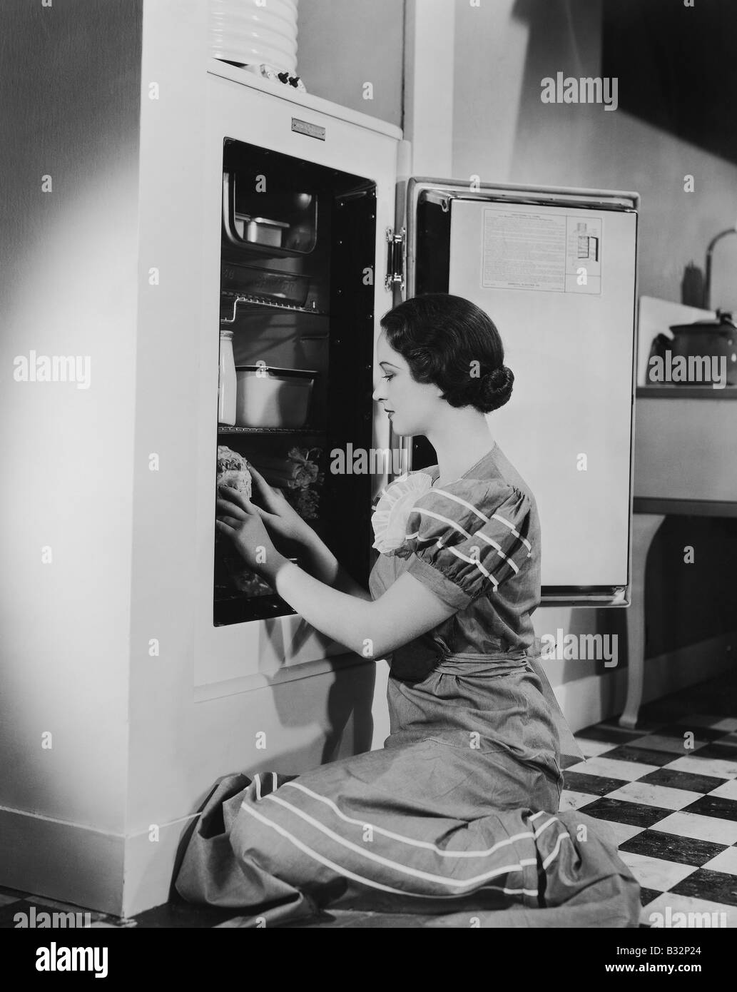 Woman with refrigerator Stock Photo - Alamy