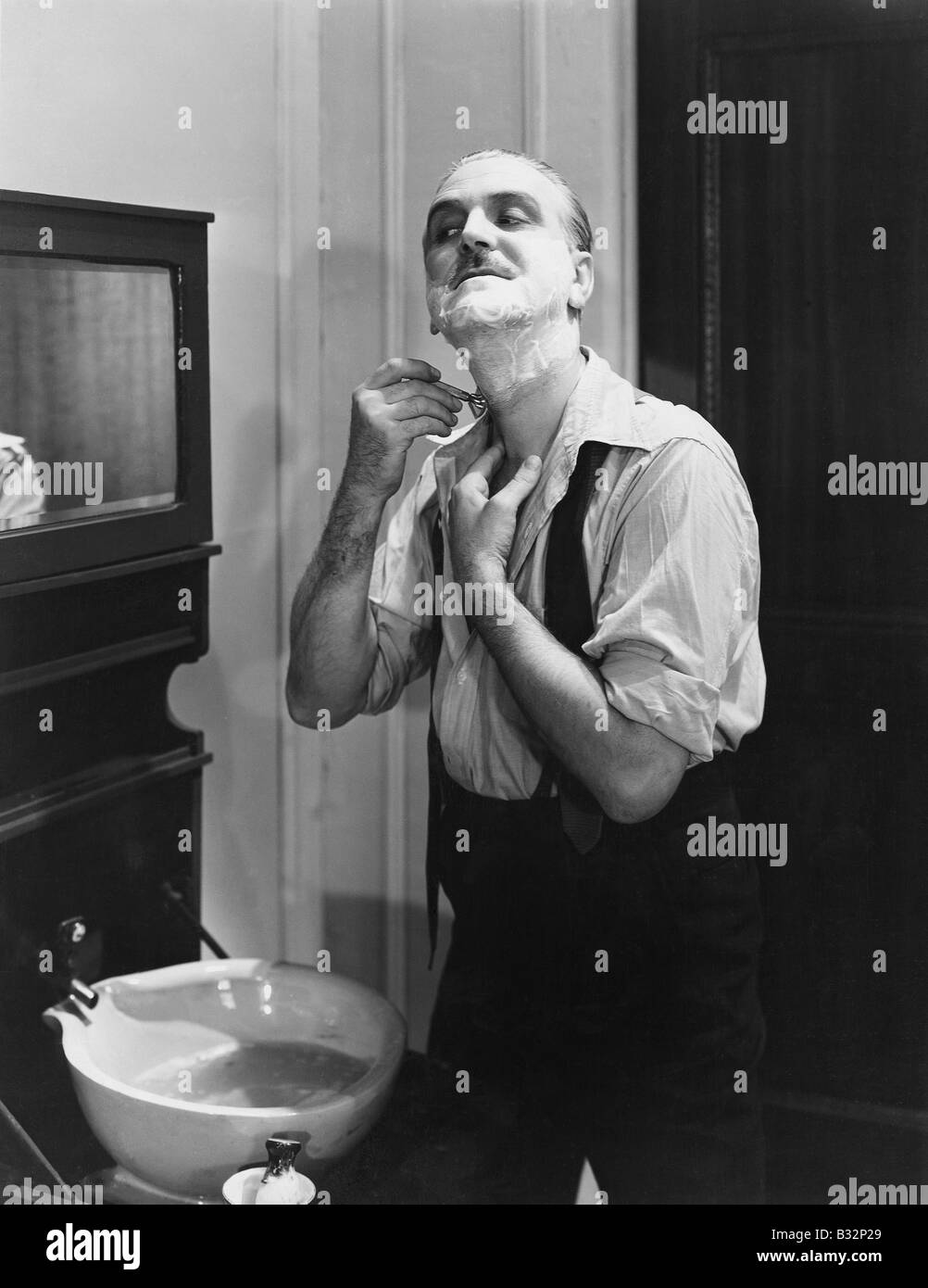 Portrait of man shaving Stock Photo - Alamy