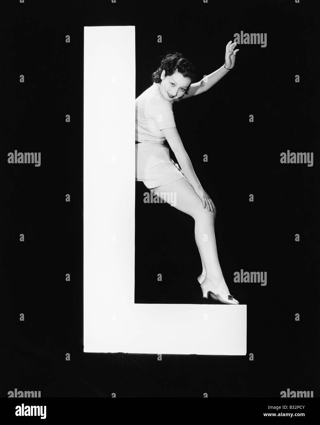 Woman with huge letter L Stock Photo - Alamy