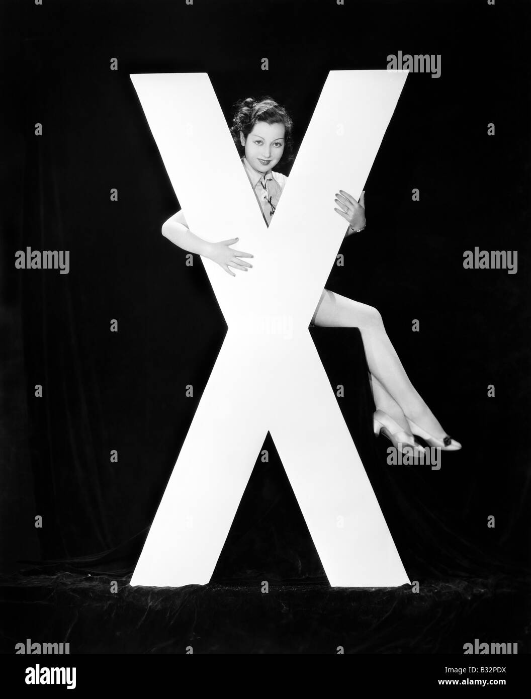 Woman with huge letter X Stock Photo - Alamy