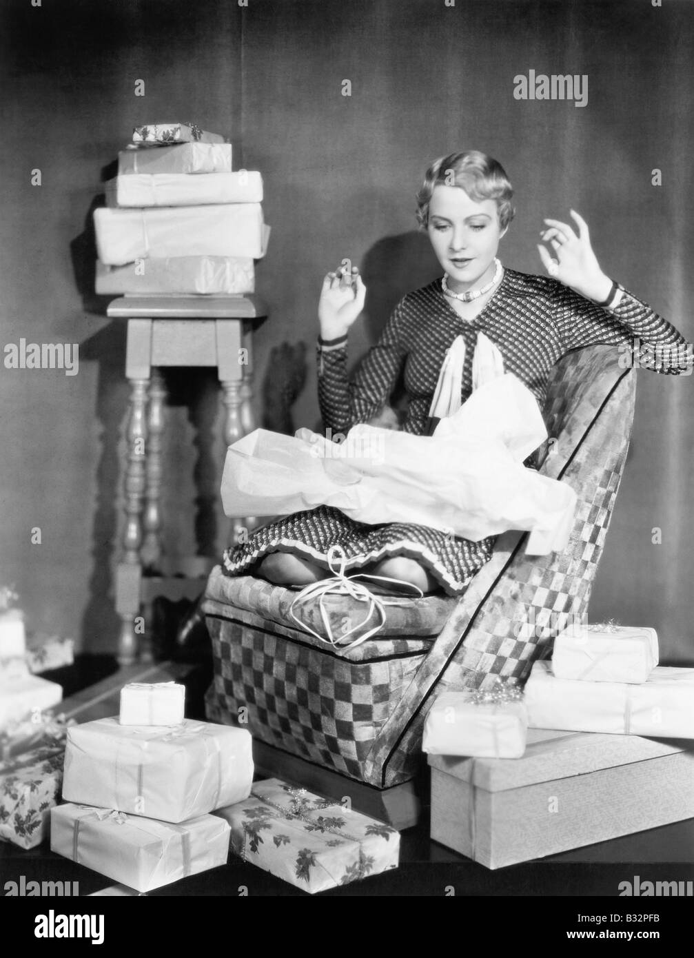 Surprised young woman opening gifts hi-res stock photography and images ...