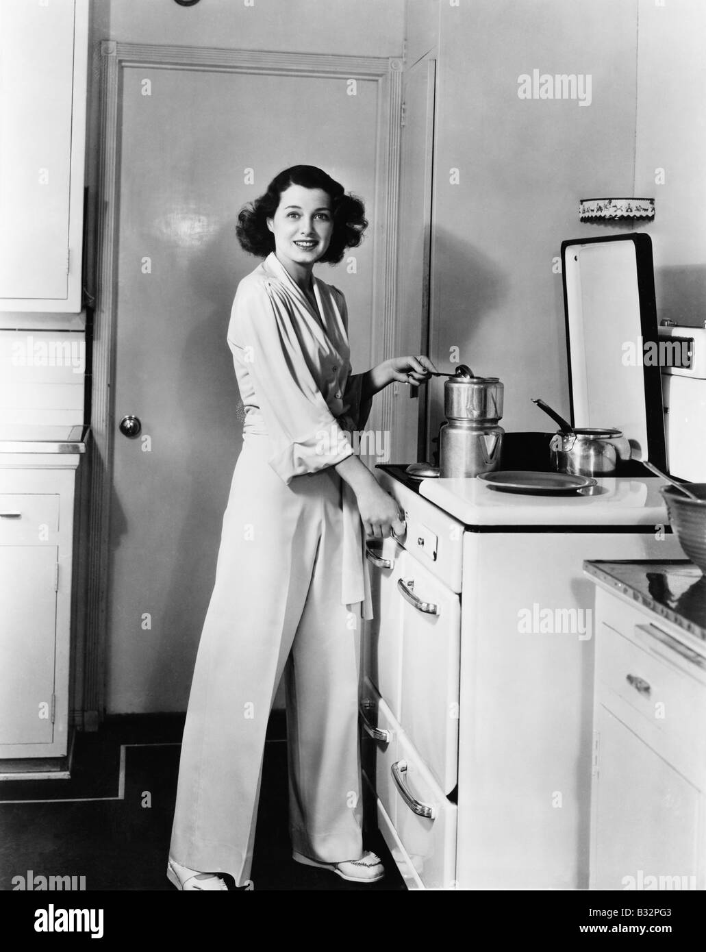 Woman cooking coffee kitchen Black and White Stock Photos & Images - Alamy
