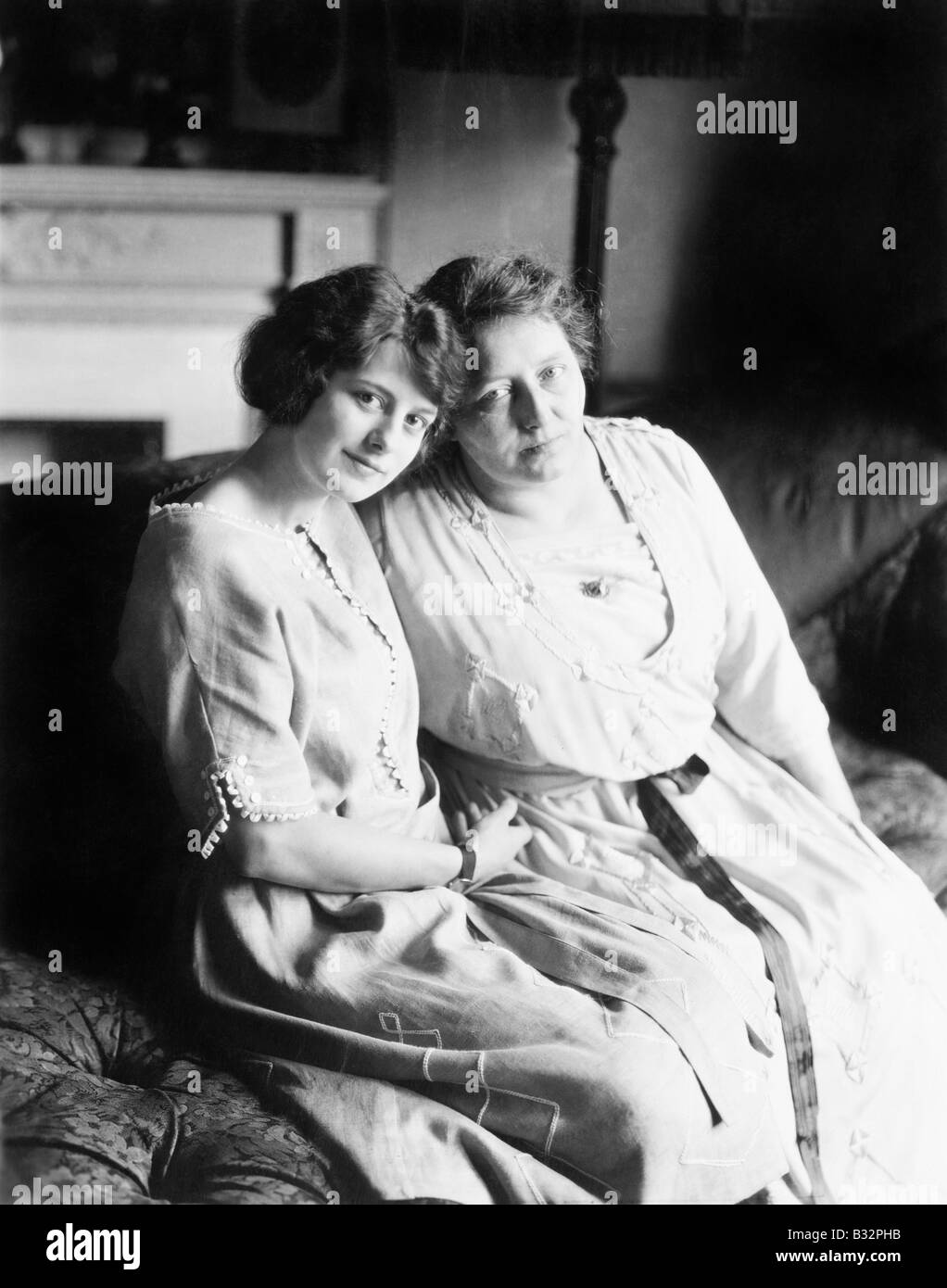 Daughter mother sitting in Black and White Stock Photos & Images - Alamy