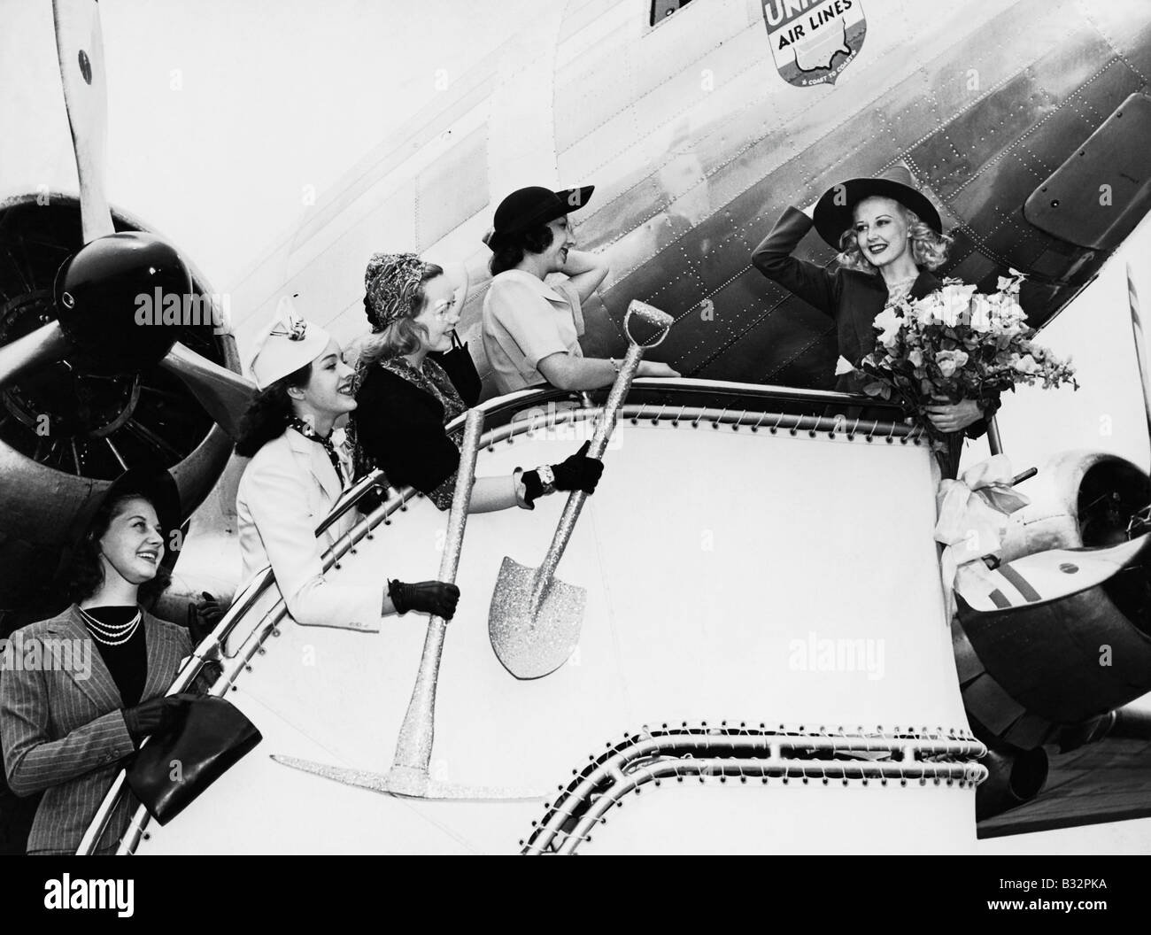 Women sending off friend boarding plane Stock Photo - Alamy