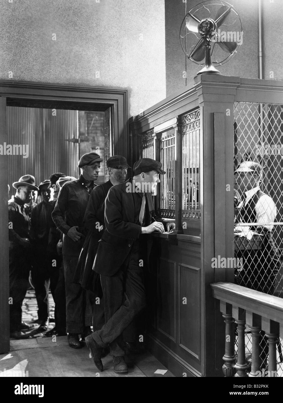 Men waiting in line to place bets Stock Photo - Alamy