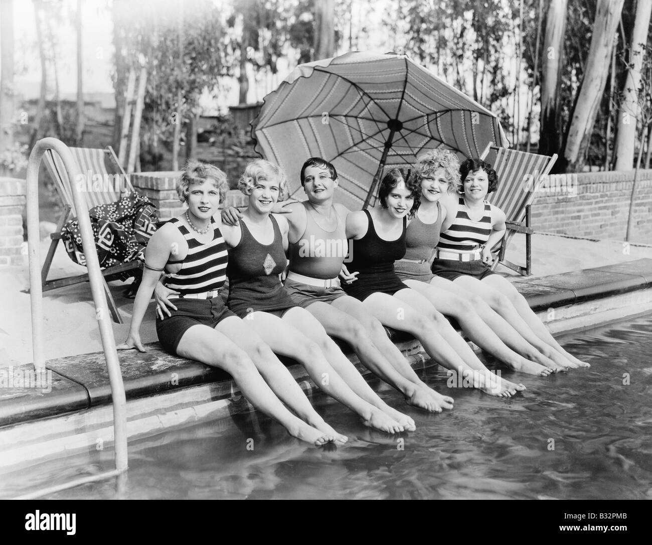 Portrait of female friends at pool Stock Photo - Alamy
