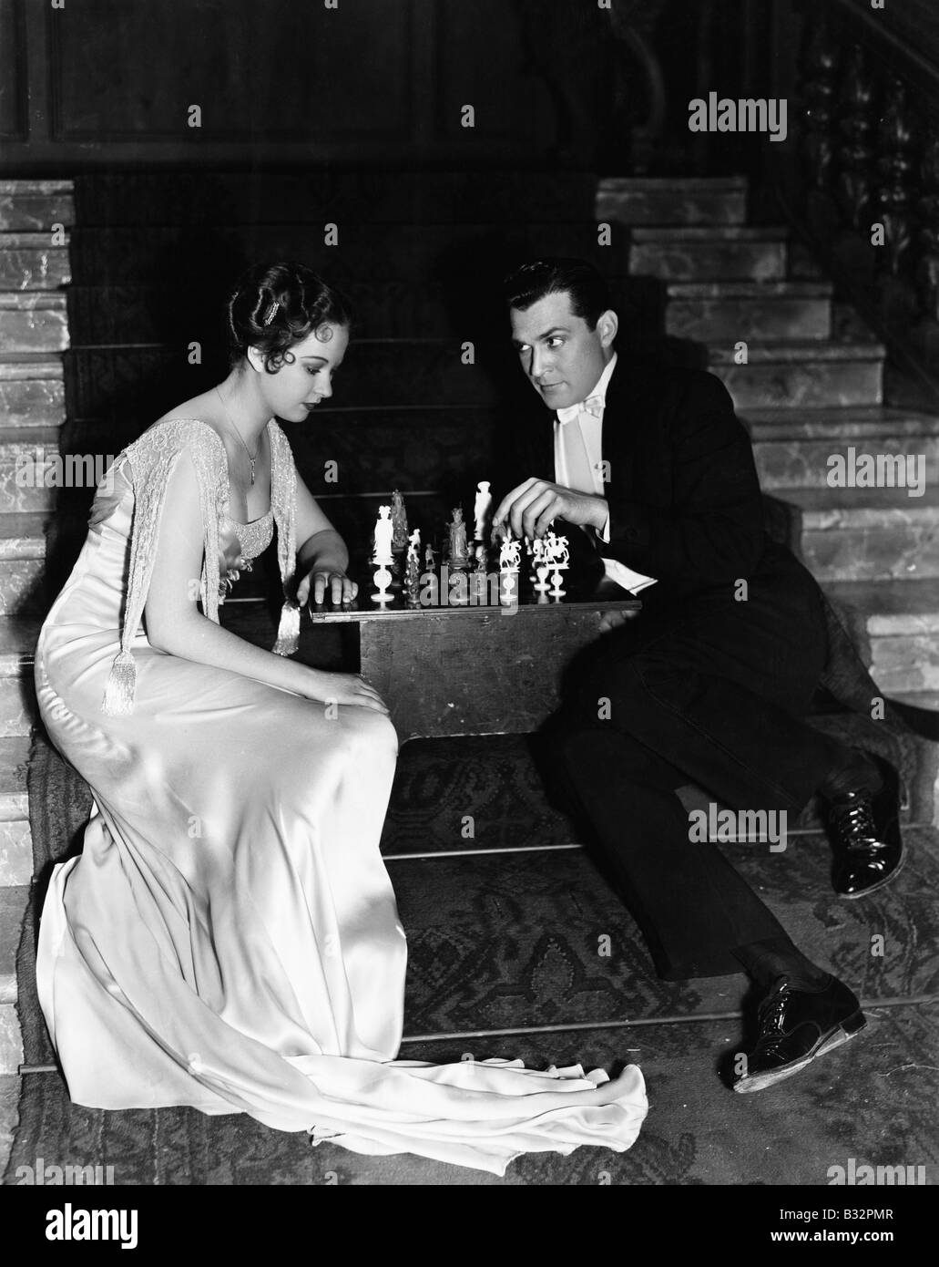 Couple playing chess Stock Photo - Alamy