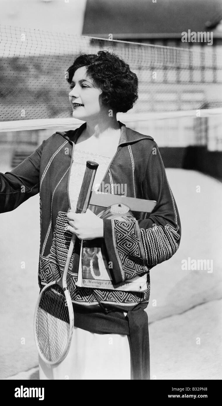 Portrait of woman with badminton racket and magazine Stock Photo - Alamy