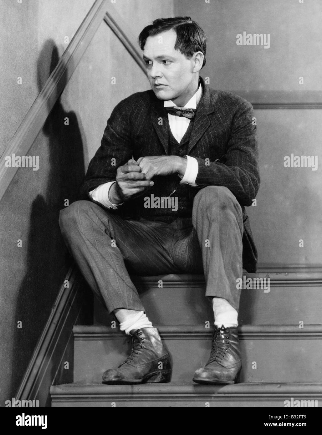 Portrait young man sitting on Black and White Stock Photos & Images - Alamy