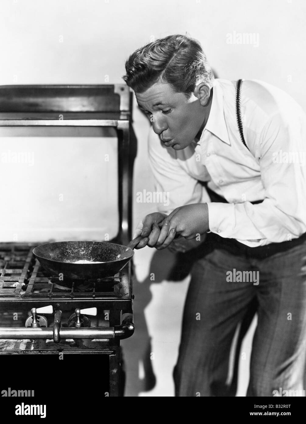 Portrait of man cooking on stove Stock Photo - Alamy