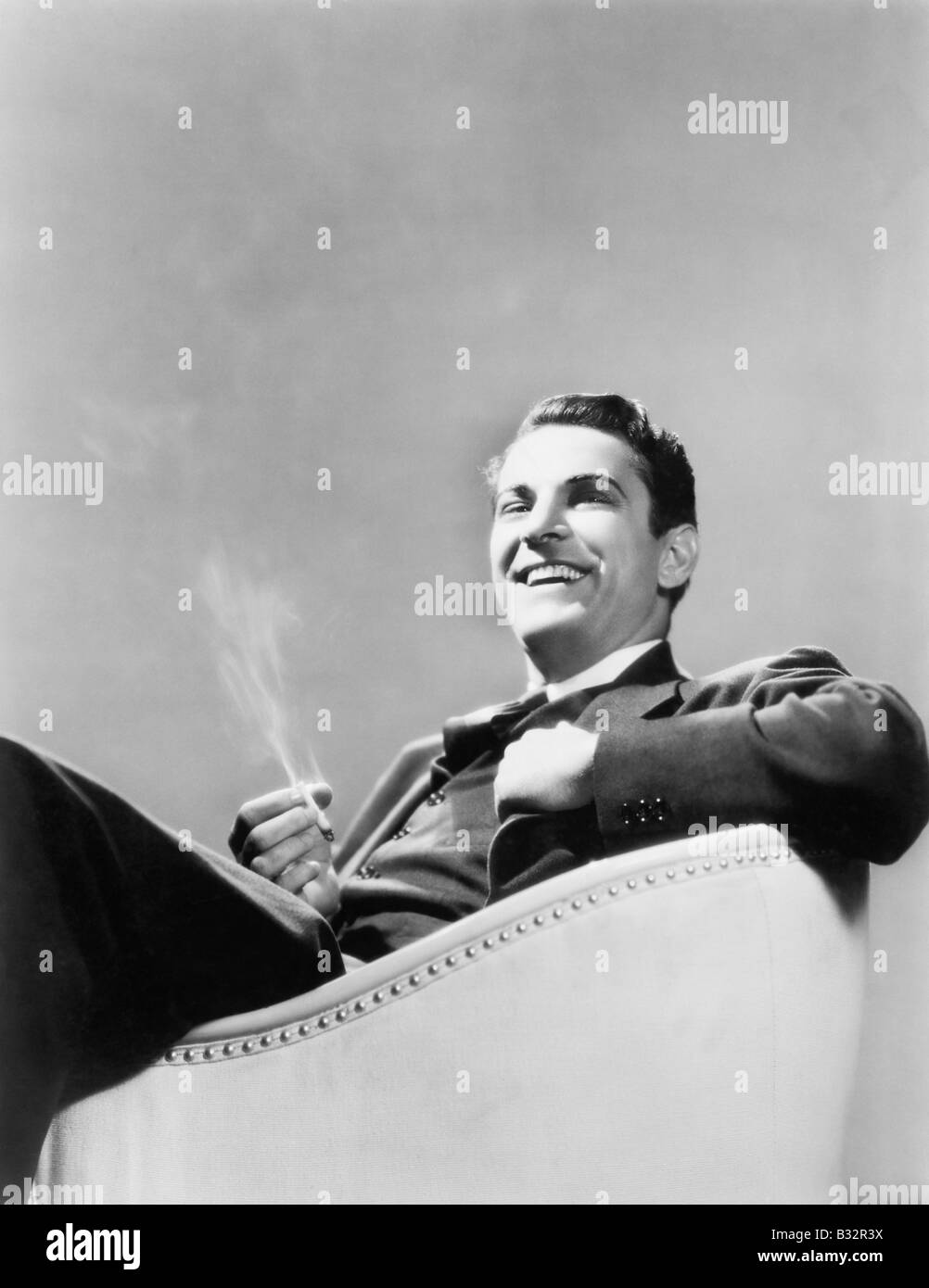 Man smoking in chair hi-res stock photography and images - Alamy