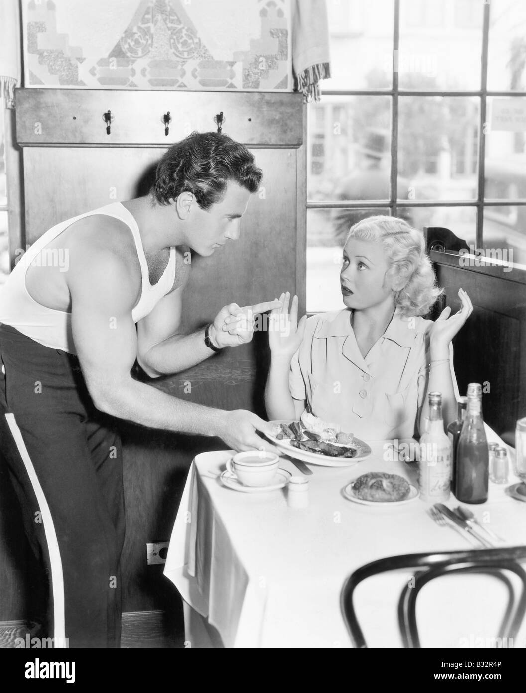 Couple in a restaurant having an argument over food Stock Photo - Alamy