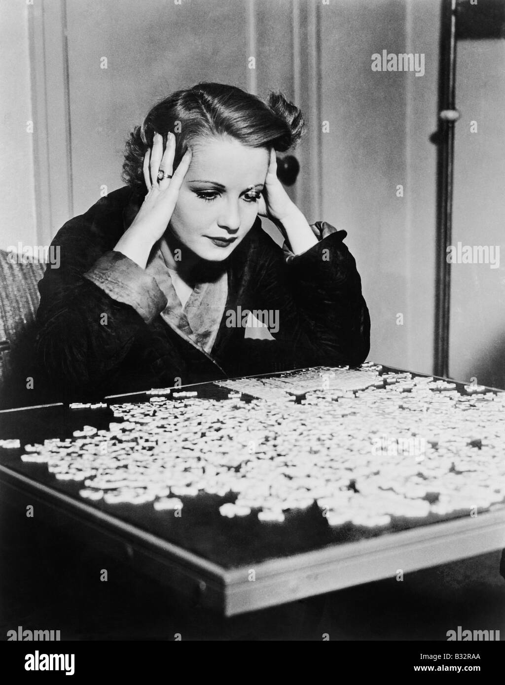 Young woman trying to solve a puzzle Stock Photo - Alamy