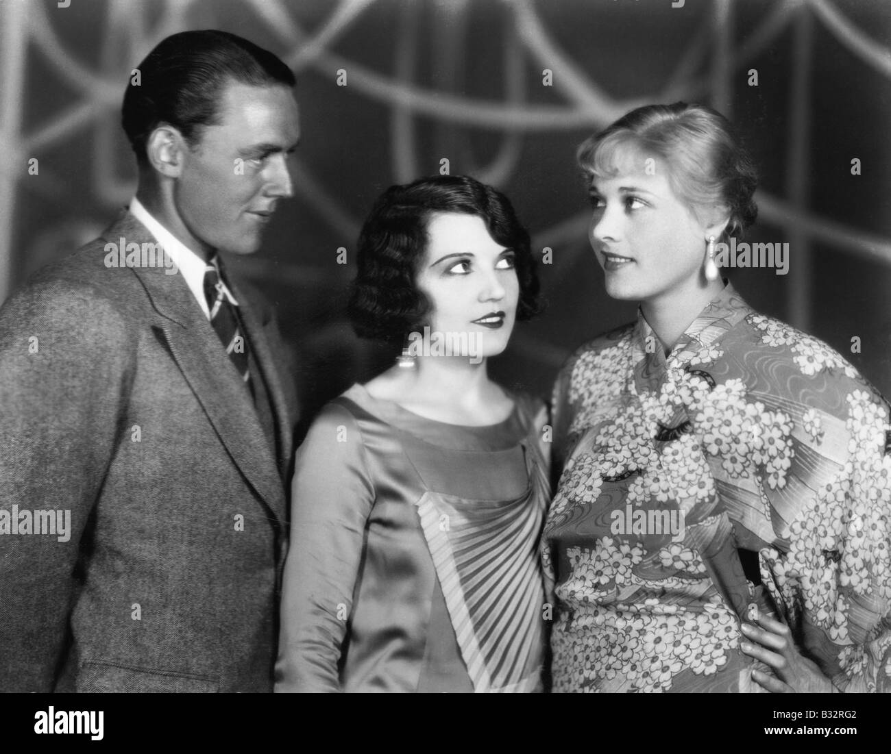 Three people standing together Stock Photo - Alamy